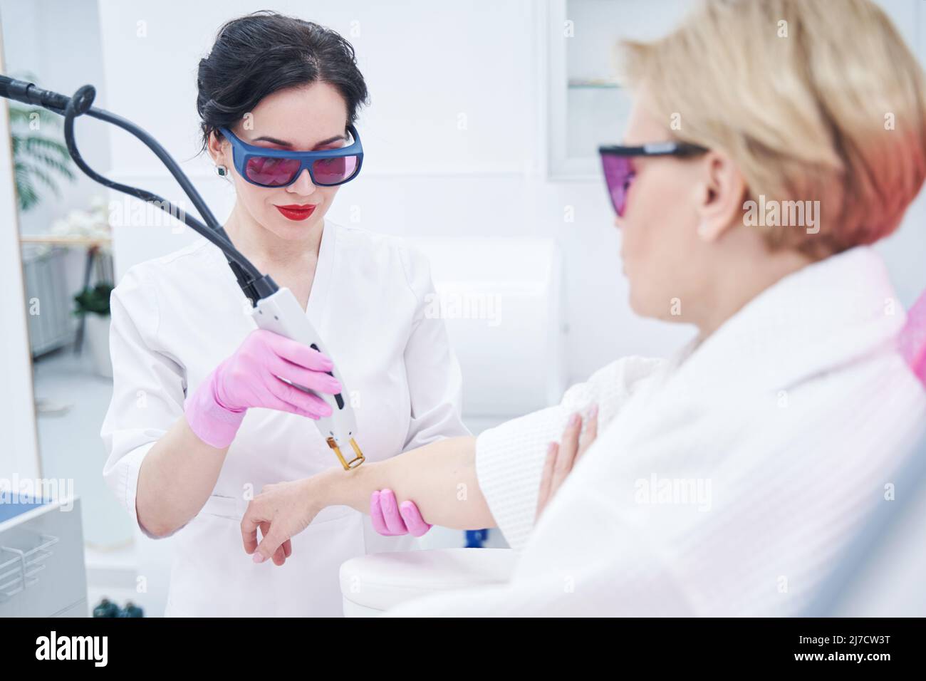 Adult woman receiving laser hair removal treatment in beauty clinic ...