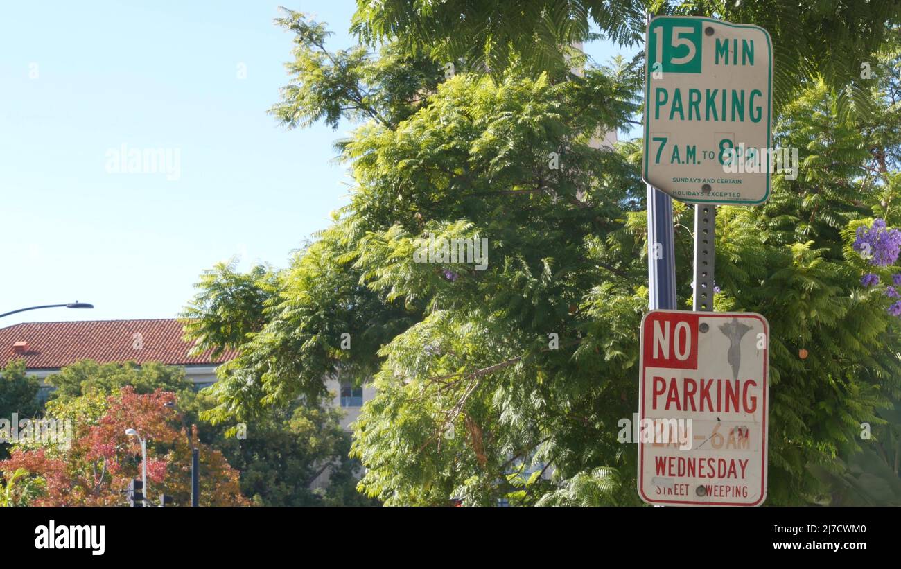 Green parking and red no parking road sign on city street in California ...