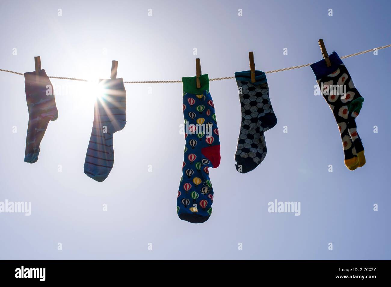 Single socks on a clothesline: 9 May 2022 is International Lost Sock ...
