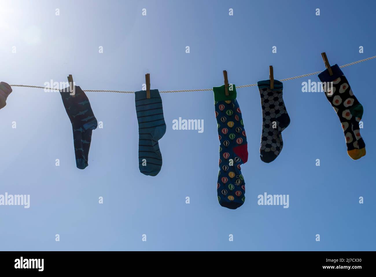 Single socks on a clothesline: 9 May 2022 is International Lost Sock ...