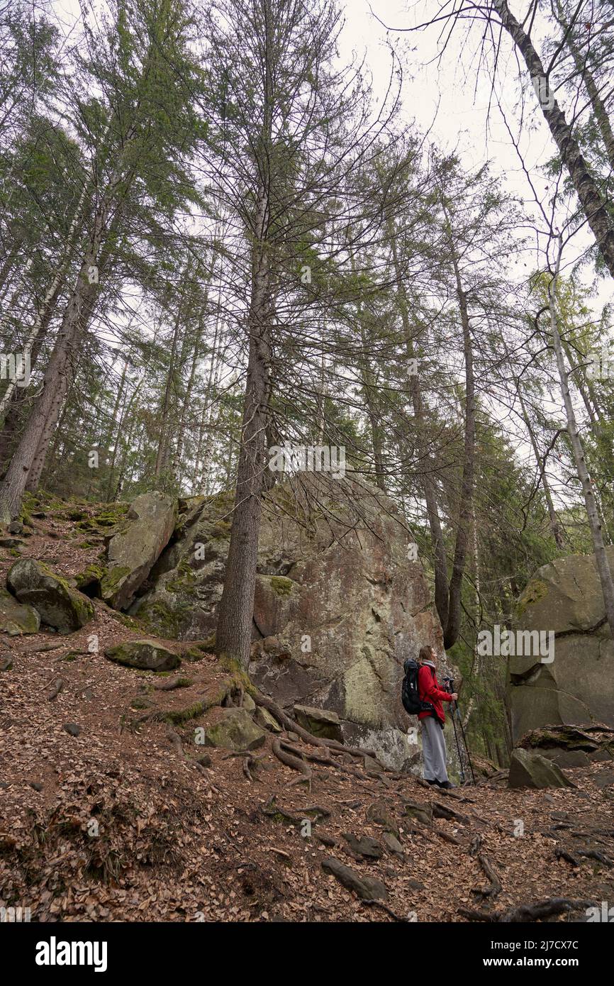 Female coming to passage between two rocks during hiking Stock Photo ...