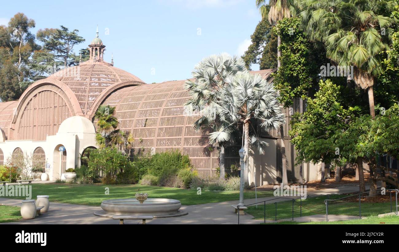 Botanical building exterior or facade in garden, green grass lawn, palm ...