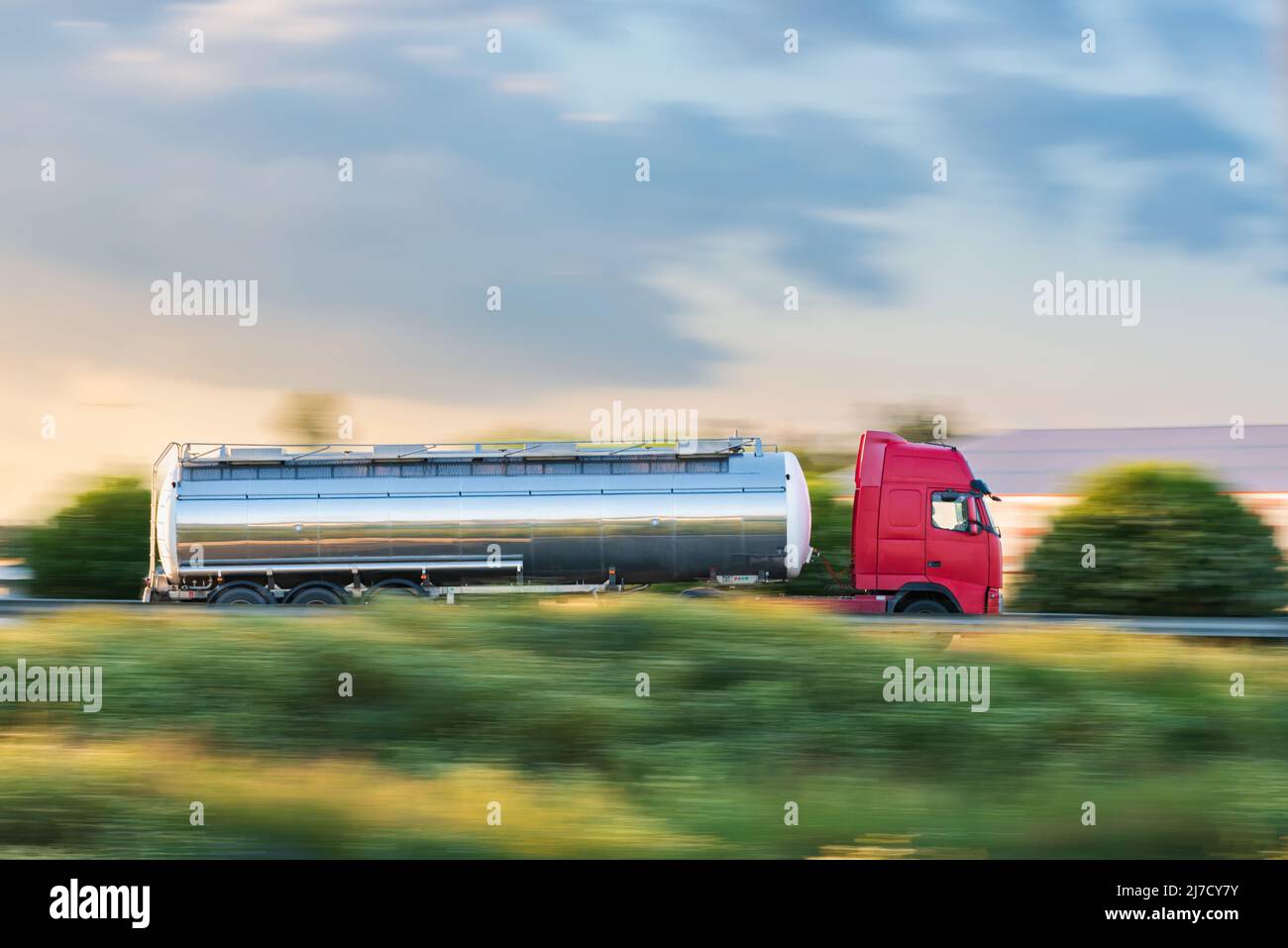 Tanker truck driving fast on the highway, side view Stock Photo - Alamy