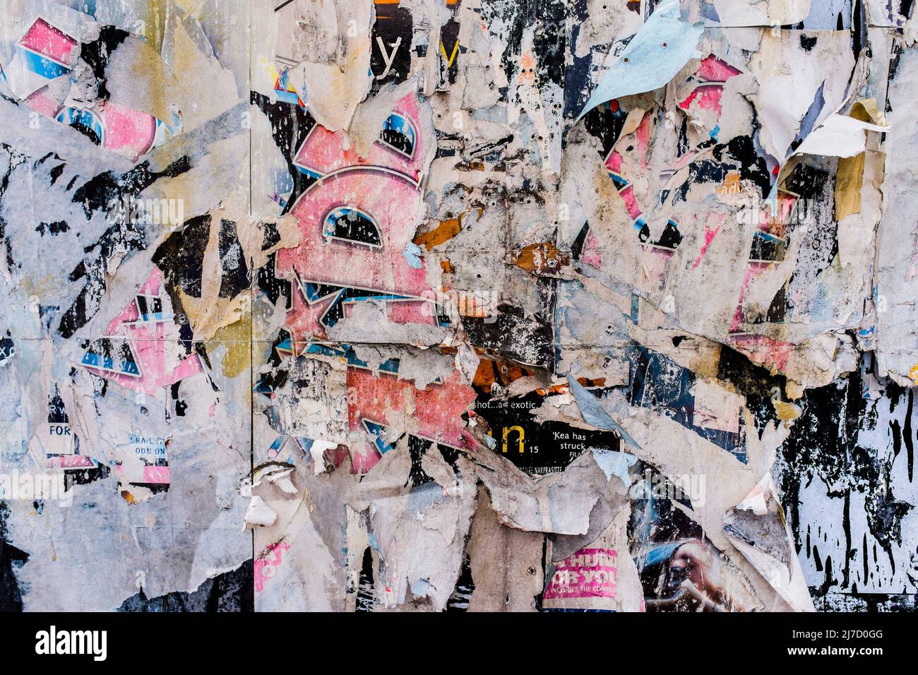 Torn posters creating a décollage effect, London, UK Stock Photo - Alamy