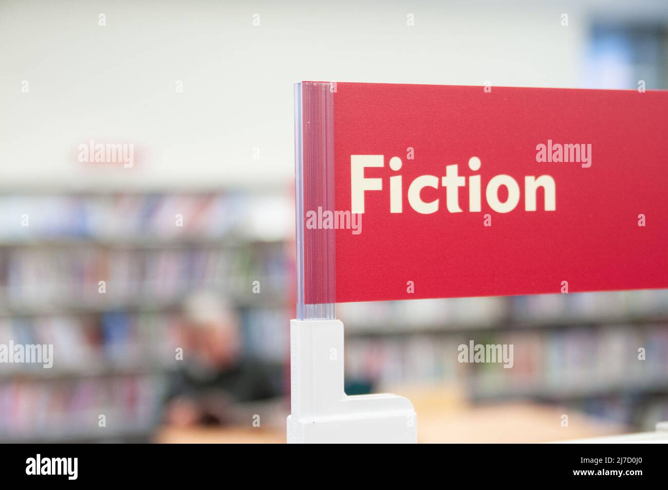 Fiction sign with library shelves in the background Stock Photo - Alamy