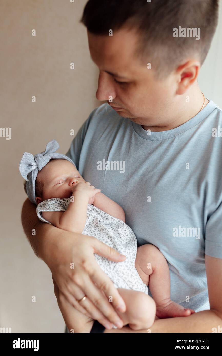 Young Caucasian father holding newborn baby girl. Male man parent and ... Young Caucasian father holding newborn baby girl. Male man parent and ...