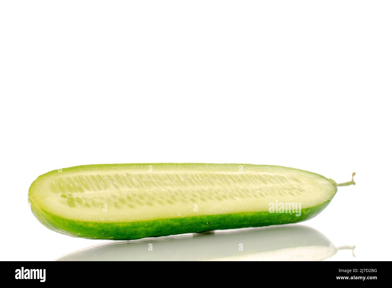 One half of a juicy smooth cucumber, macro, isolated on a white ...