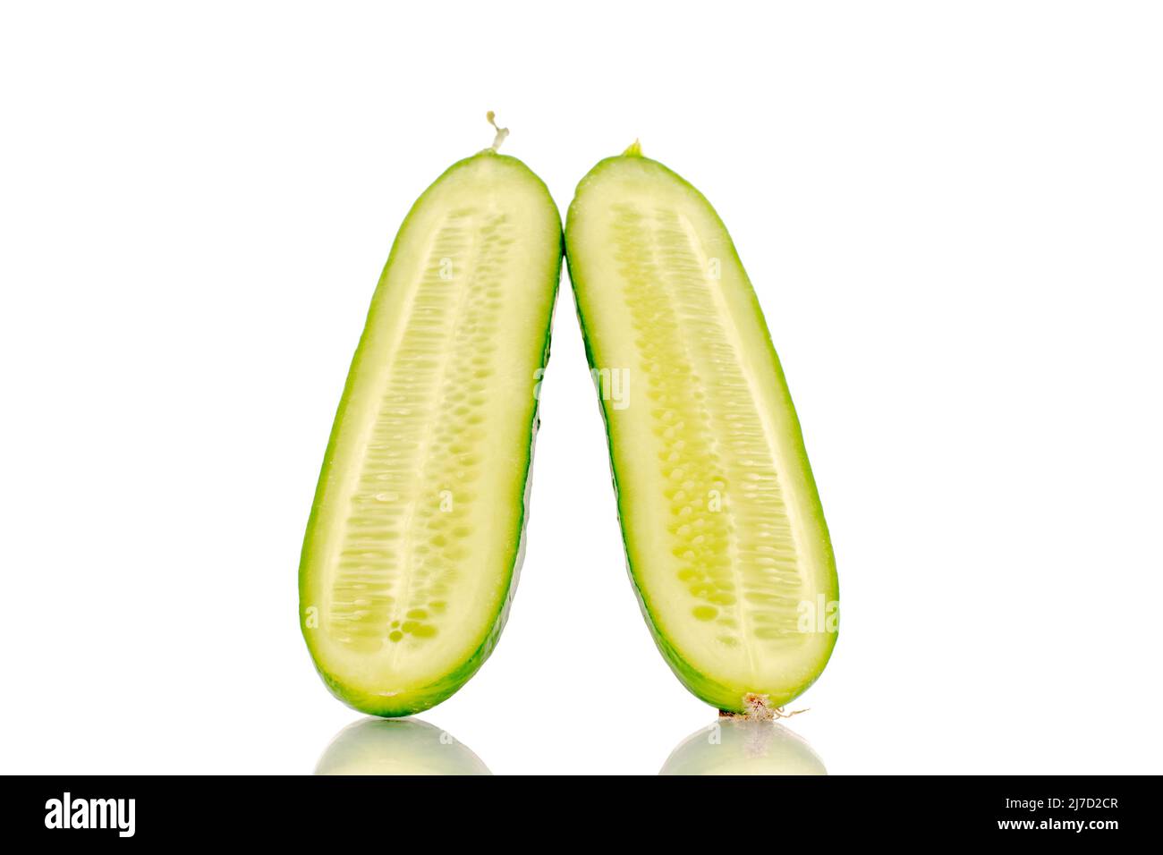 Two halves of a juicy smooth cucumber, macro, isolated on a white ...