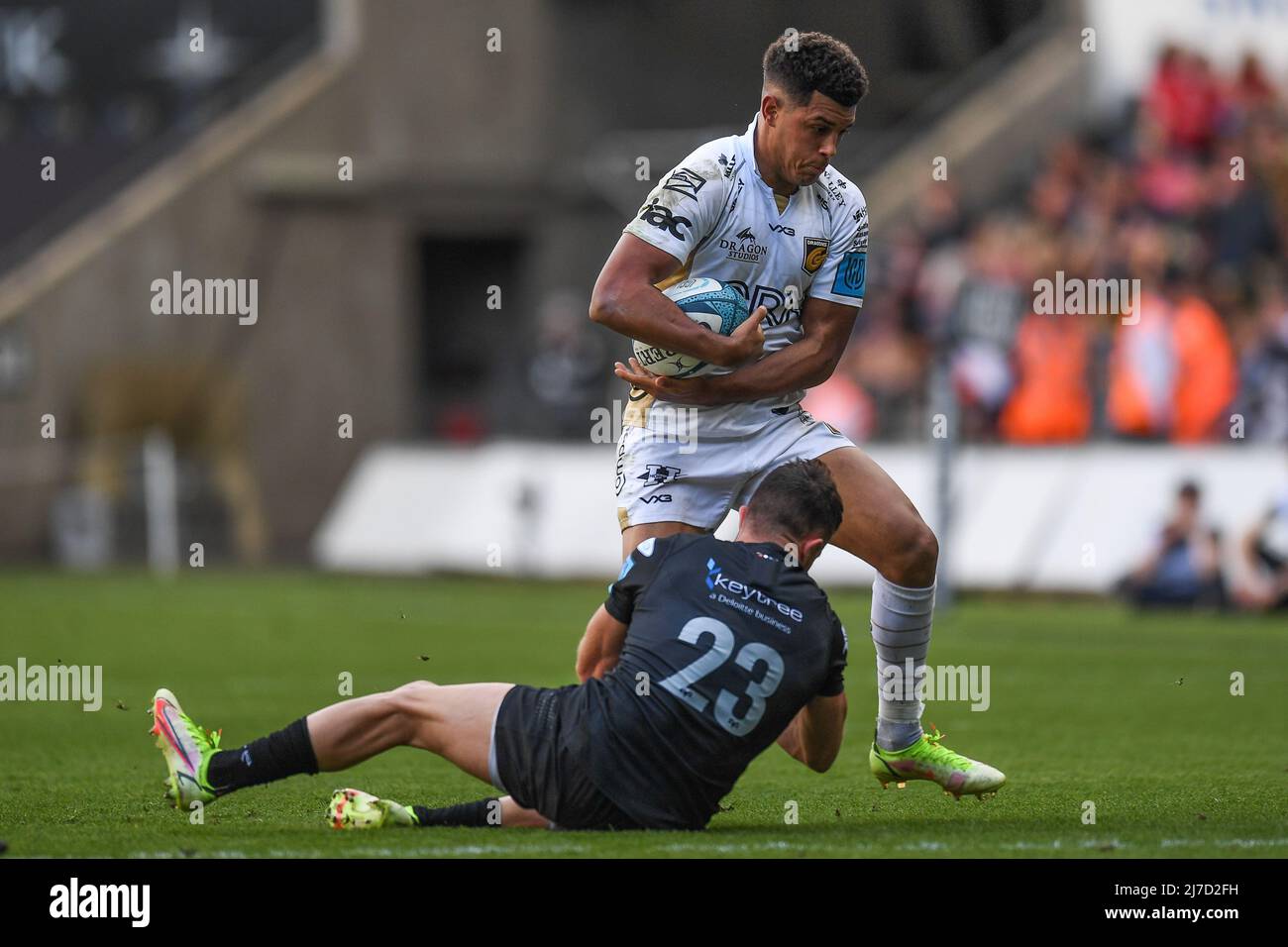 Luke Morgan of Ospreys, tackles Rio Dyer of Dragons Stock Photo - Alamy