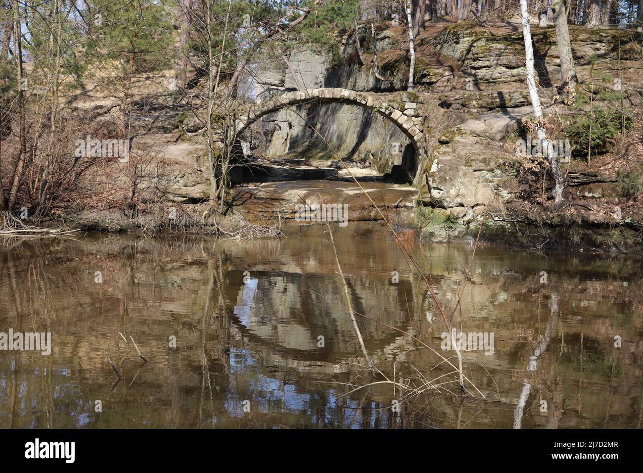 An ancient stone bridge spanning between two sandstone rocks between ...