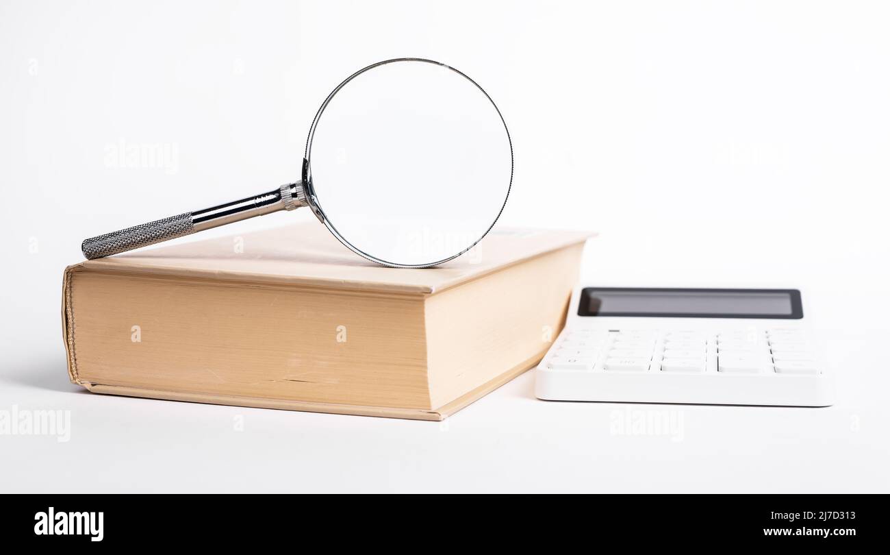 Book with magnifying glass and calculator. Math, statistical knowledge ...