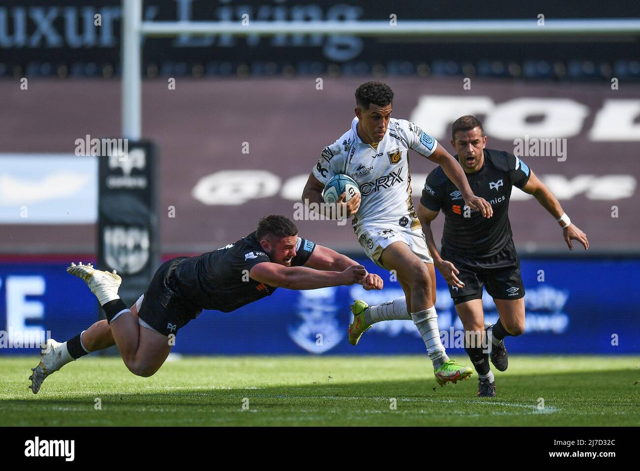 Rio Dyer of Dragons, evades the tackle of Tom Botha of Ospreys Stock ...