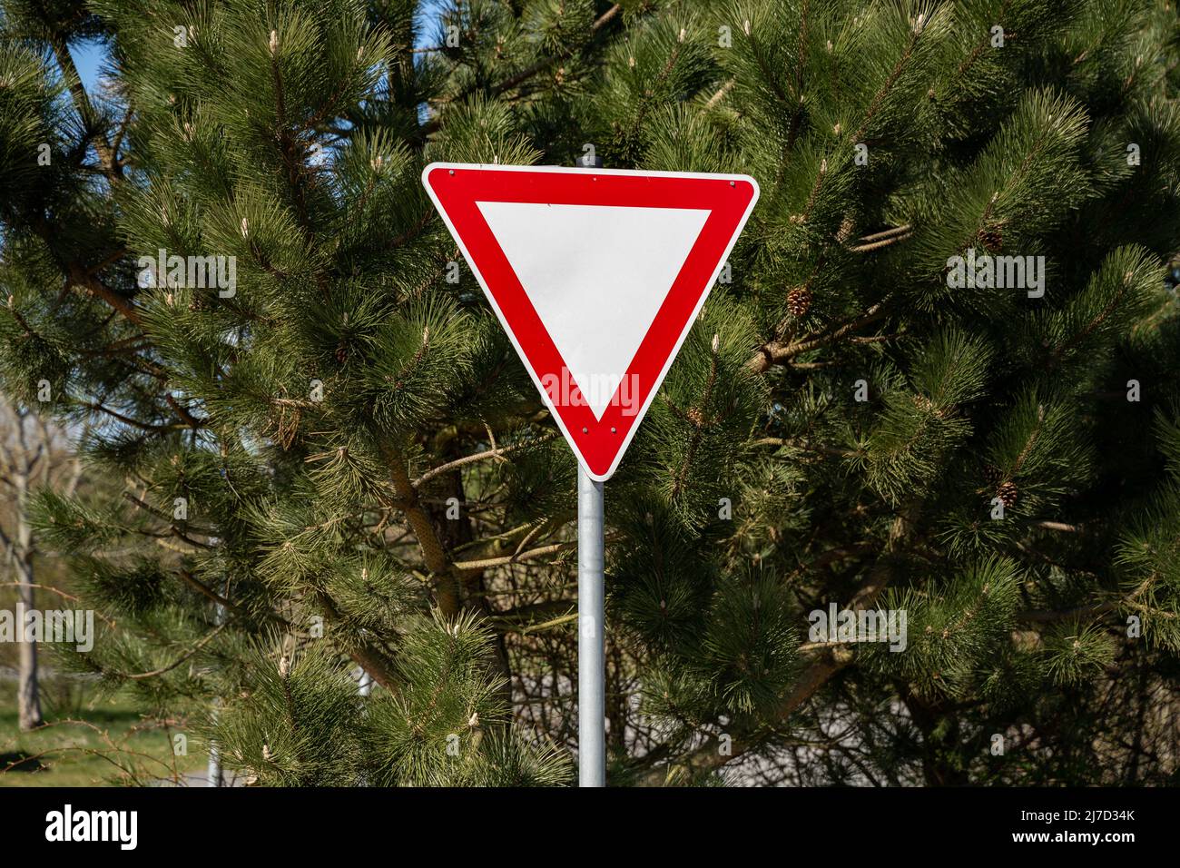 Give way road sign next to crossroads. Also called yield sign to guide ...