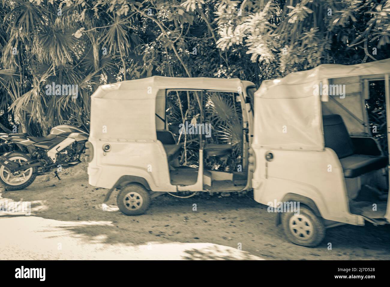 Old black and white picture of driving thru typical colorful street ...