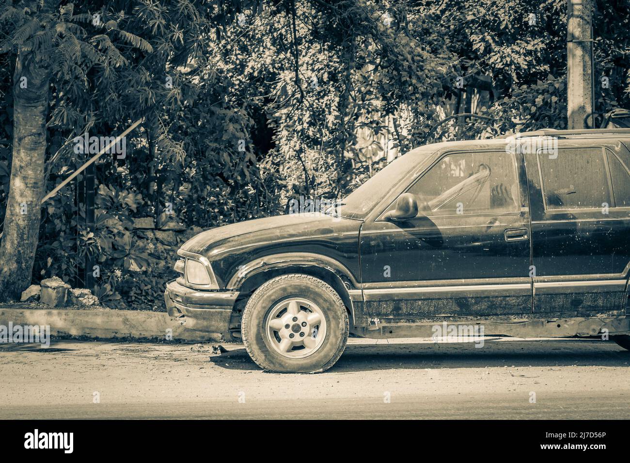 Old black and white picture of an old dirty car pick up truck at street ...