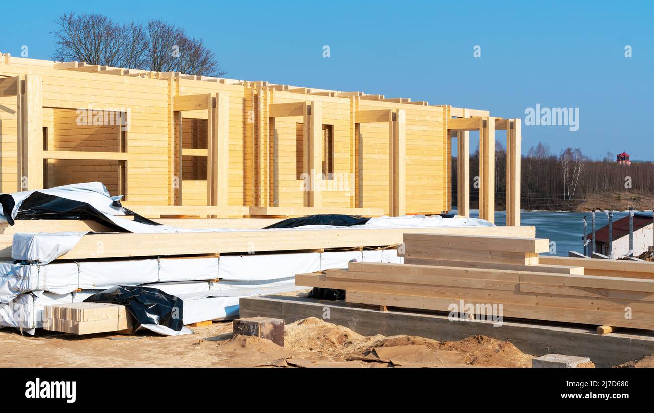 Storage of building materials at the construction site. Wooden beams ...