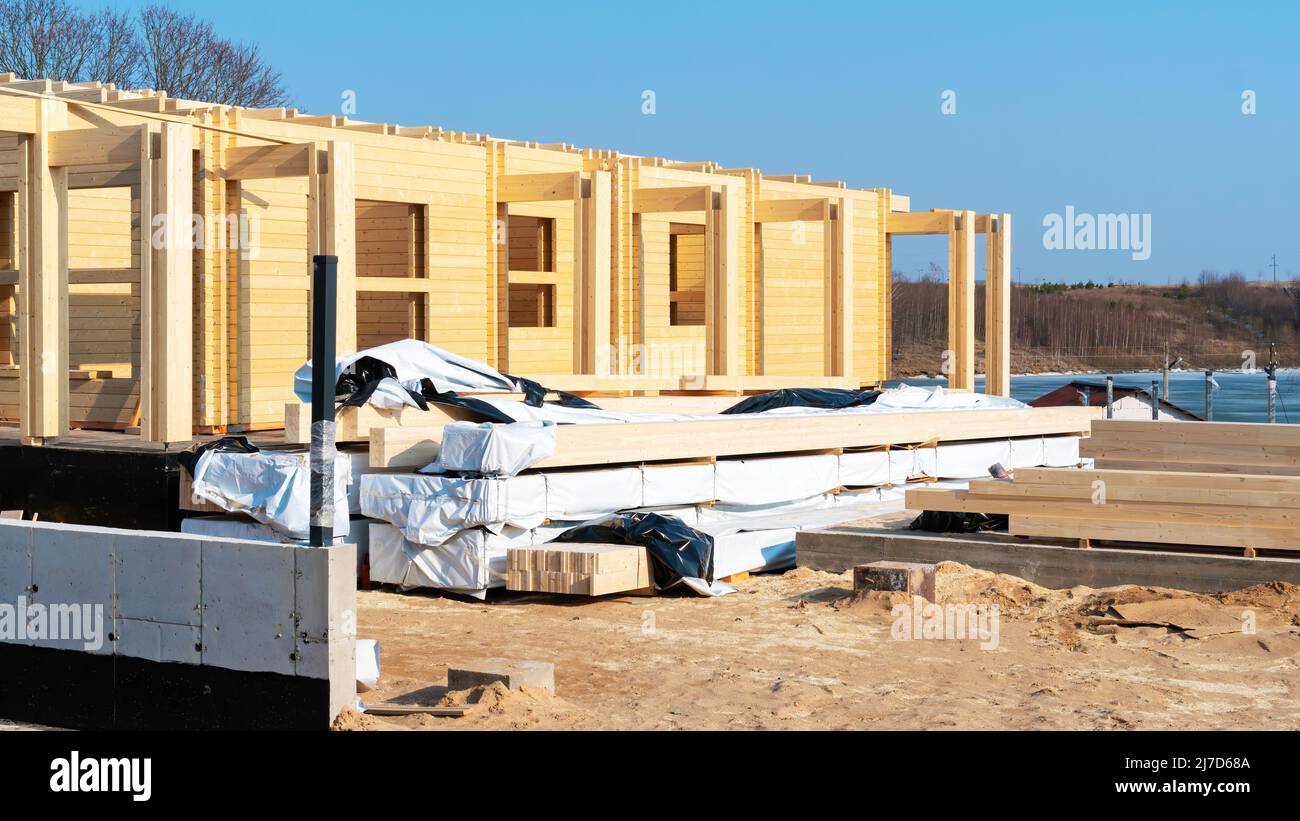 Wooden beams lie wrapped in plastic at the construction site of a ...