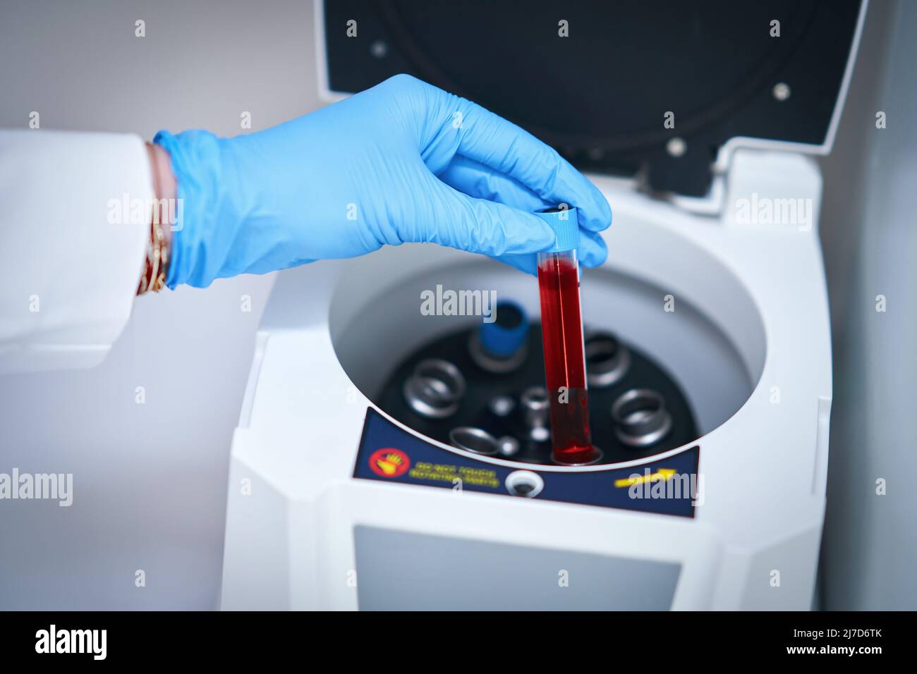 Test tube with blood and mixing machine Stock Photo - Alamy