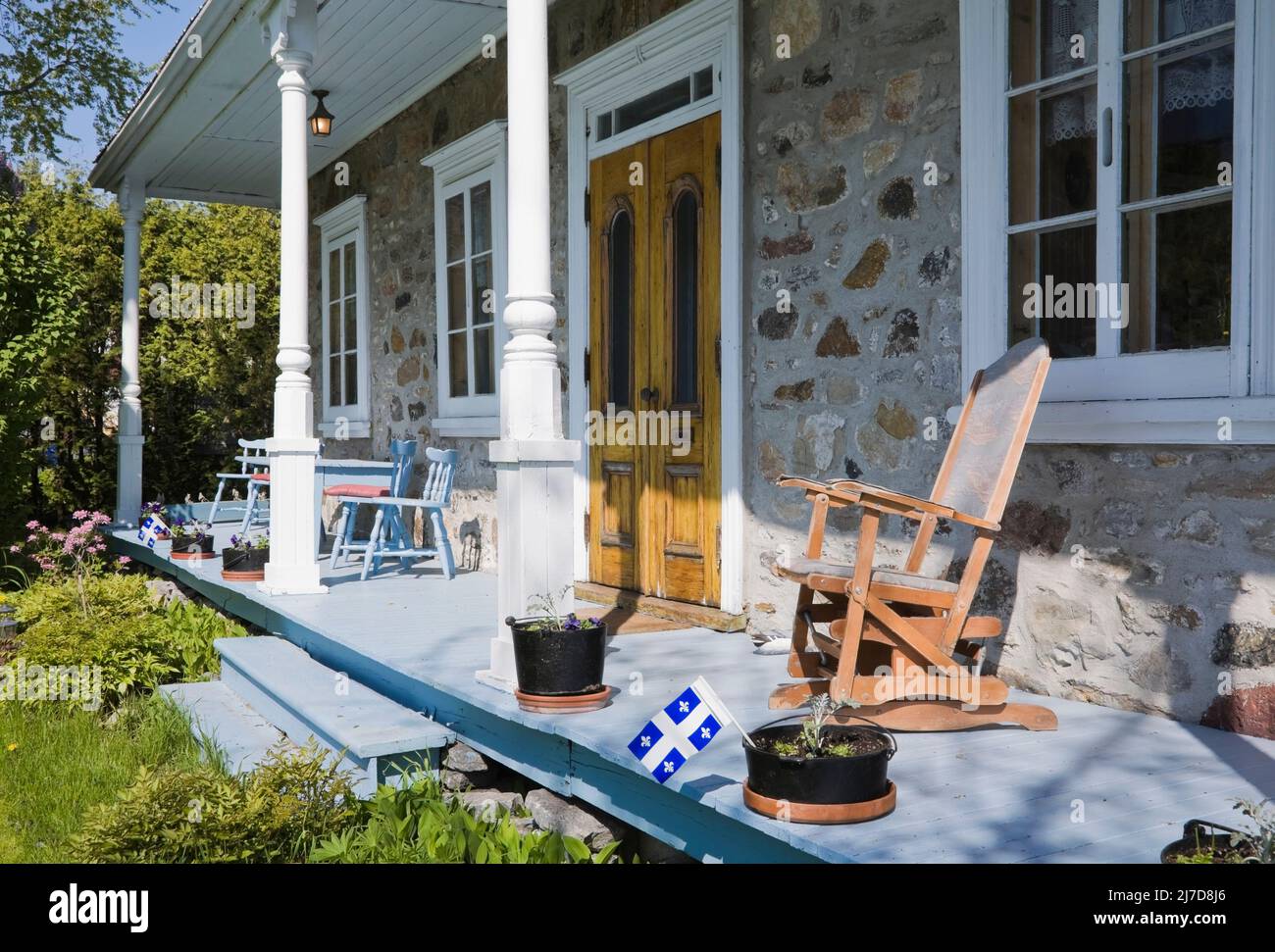 Old 1746 Canadiana cottage style fieldstone home facade with white and ...
