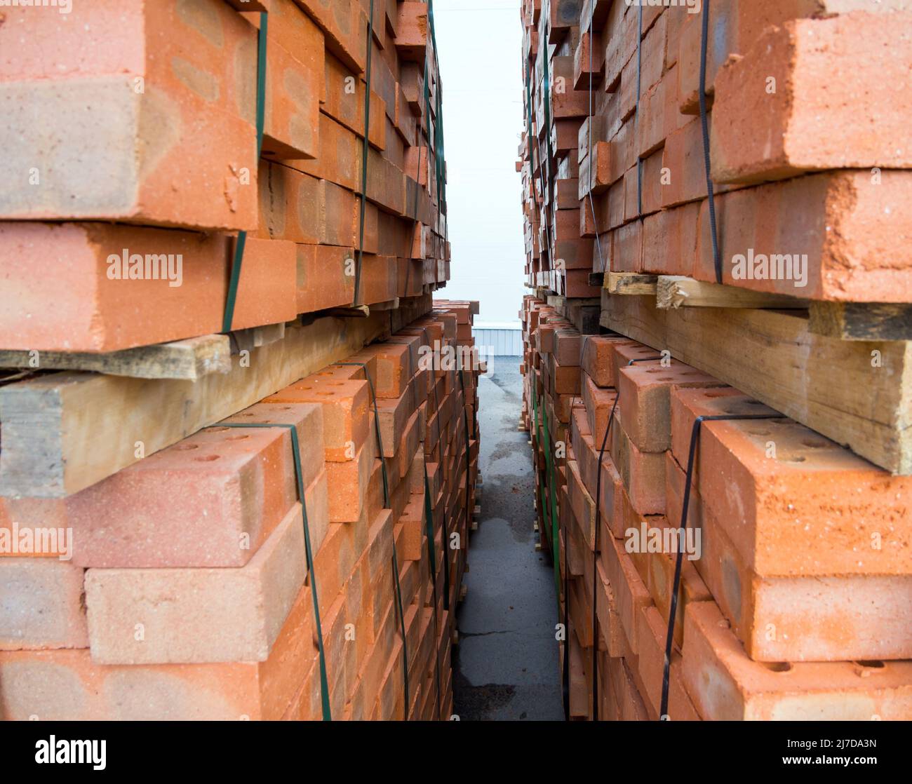 Fragment of pallets with packed red bricks Stock Photo - Alamy