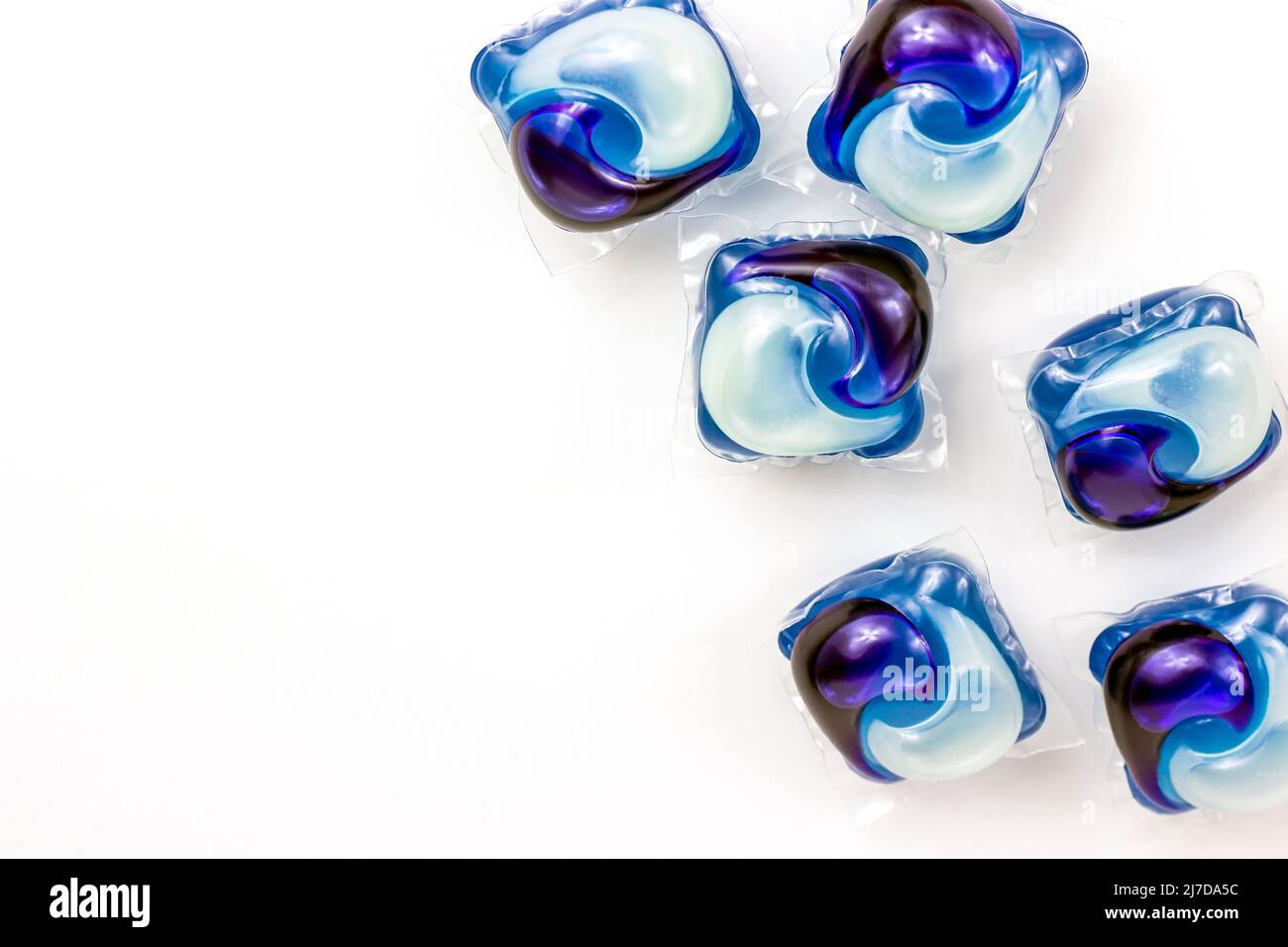 Bright blue washing pods and capsules with liquid detergent for machine ...