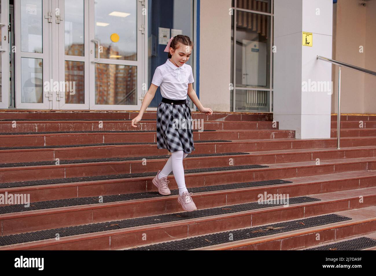 Back to school. Girl in school uniform go to school. Beginning of ...