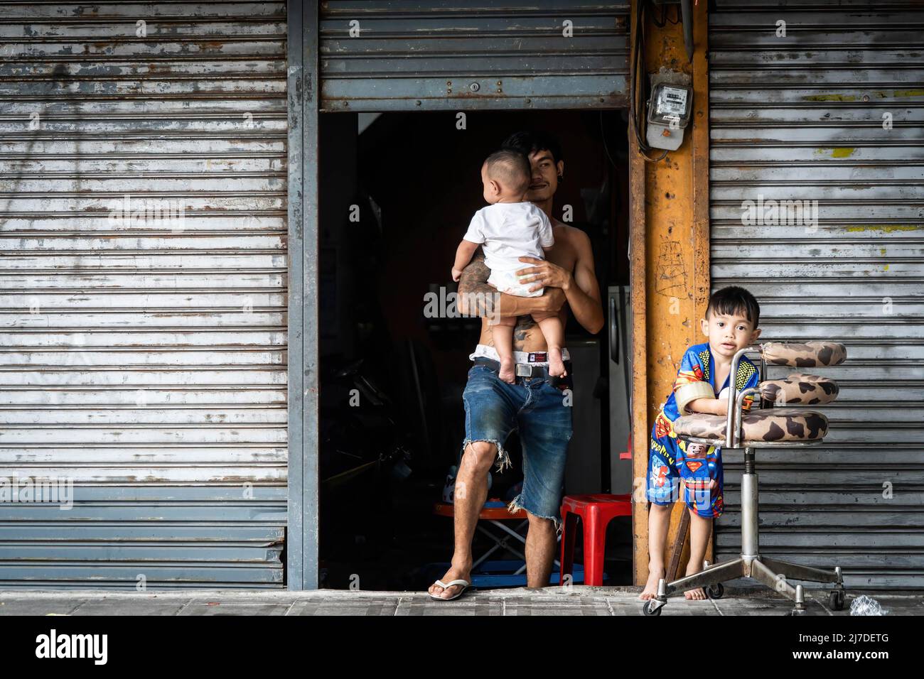 A family plays outside of their home. Thailand re-opens to tourists ...