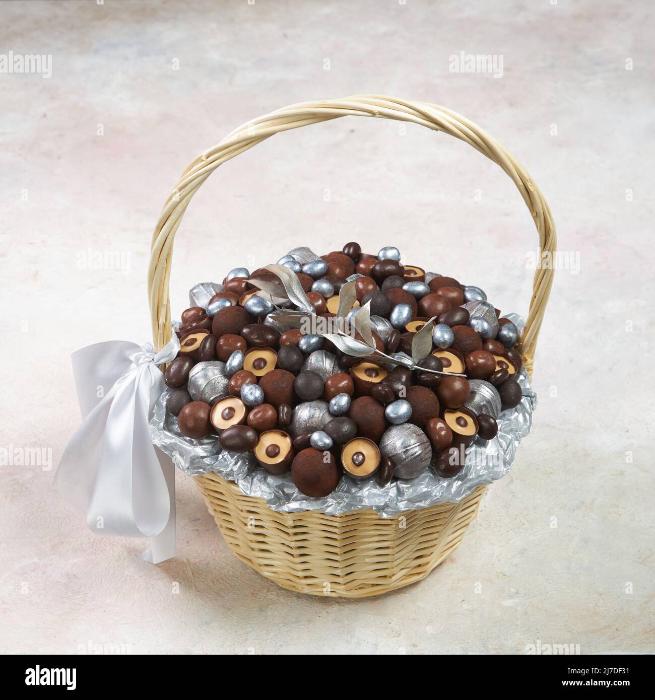 Light colour basket with filled with silver chocolate candies Stock ...