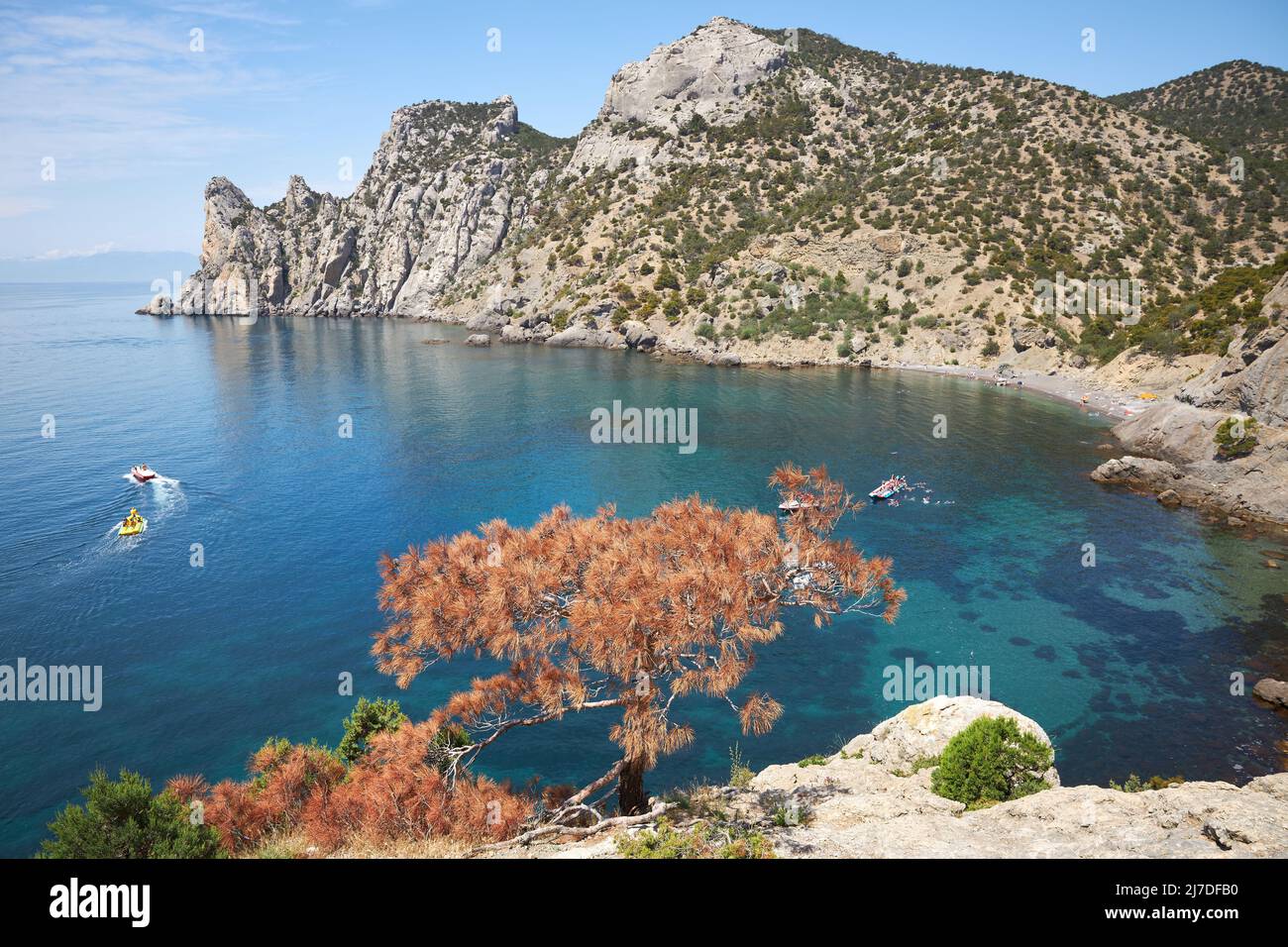 View of a blue bay with transparent water and rocks in the summer Stock ...