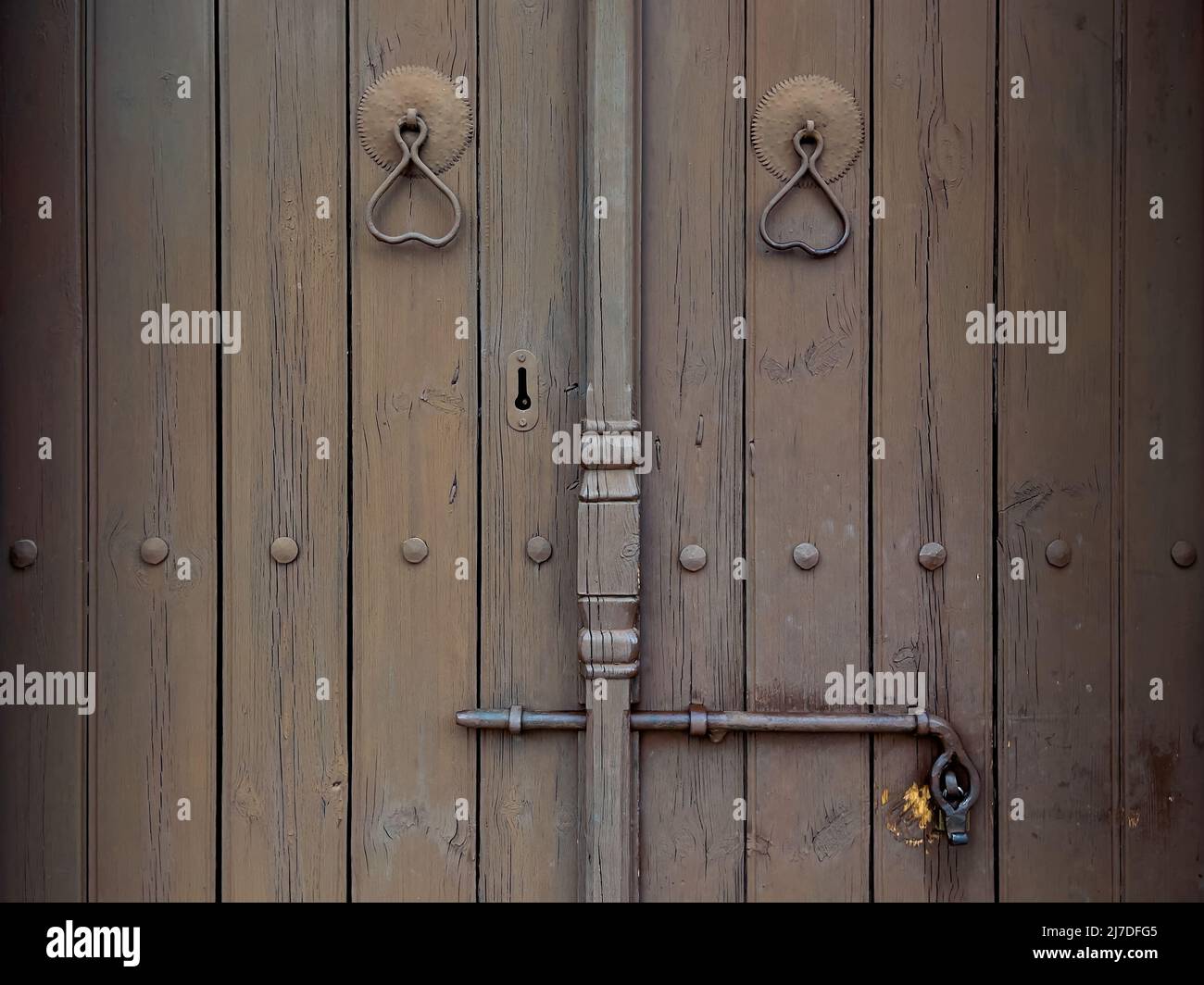 Wooden door with iron locking gear close-up Stock Photo - Alamy