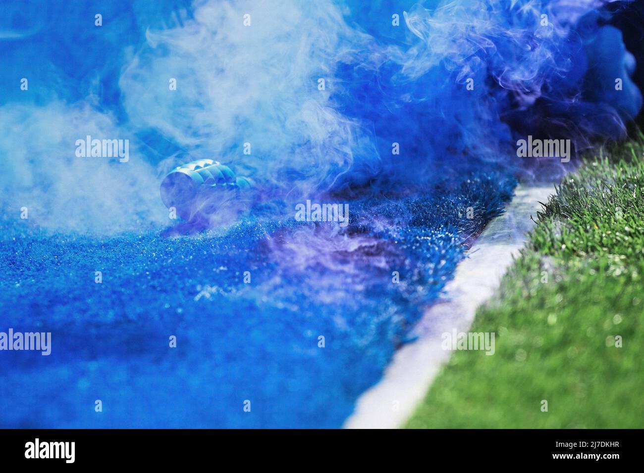 A blue smoke grenade is thrown onto the pitch during the game in , on 5 ...