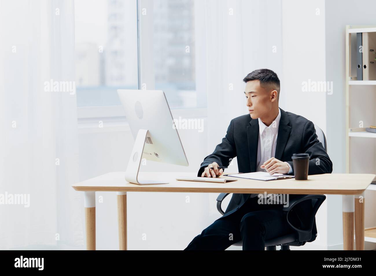 businessmen works at the computer glass of coffee emotion office ...