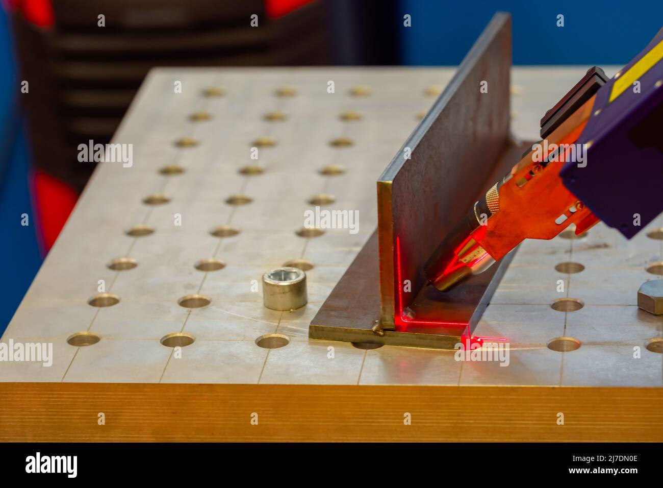 Industrial welding robotic arm scanning metal workpiece with laser ...