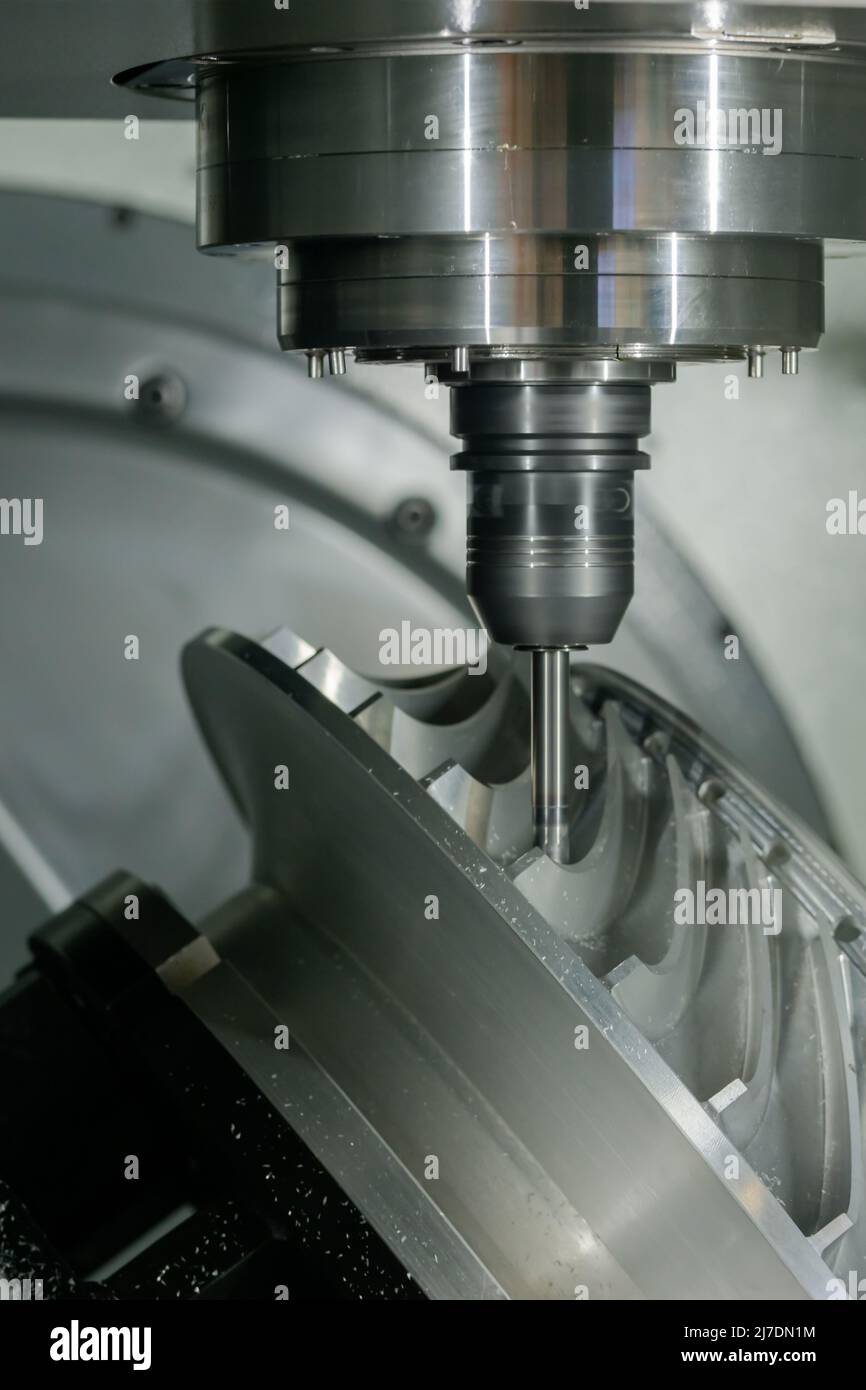 Close up: cnc turning milling machine cutting metal workpiece at ...