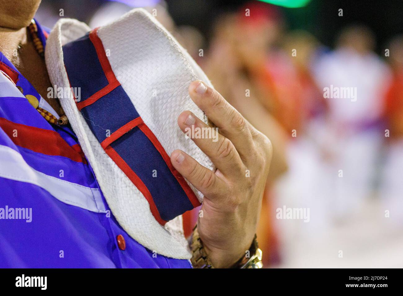 man holding a hat at chest height in Rio de Janeiro Stock Photo - Alamy