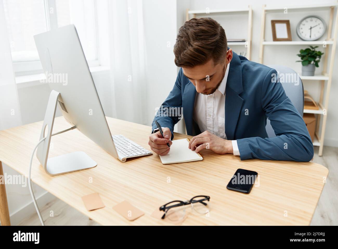 manager sitting at the computer work boss Gray background Stock Photo ...