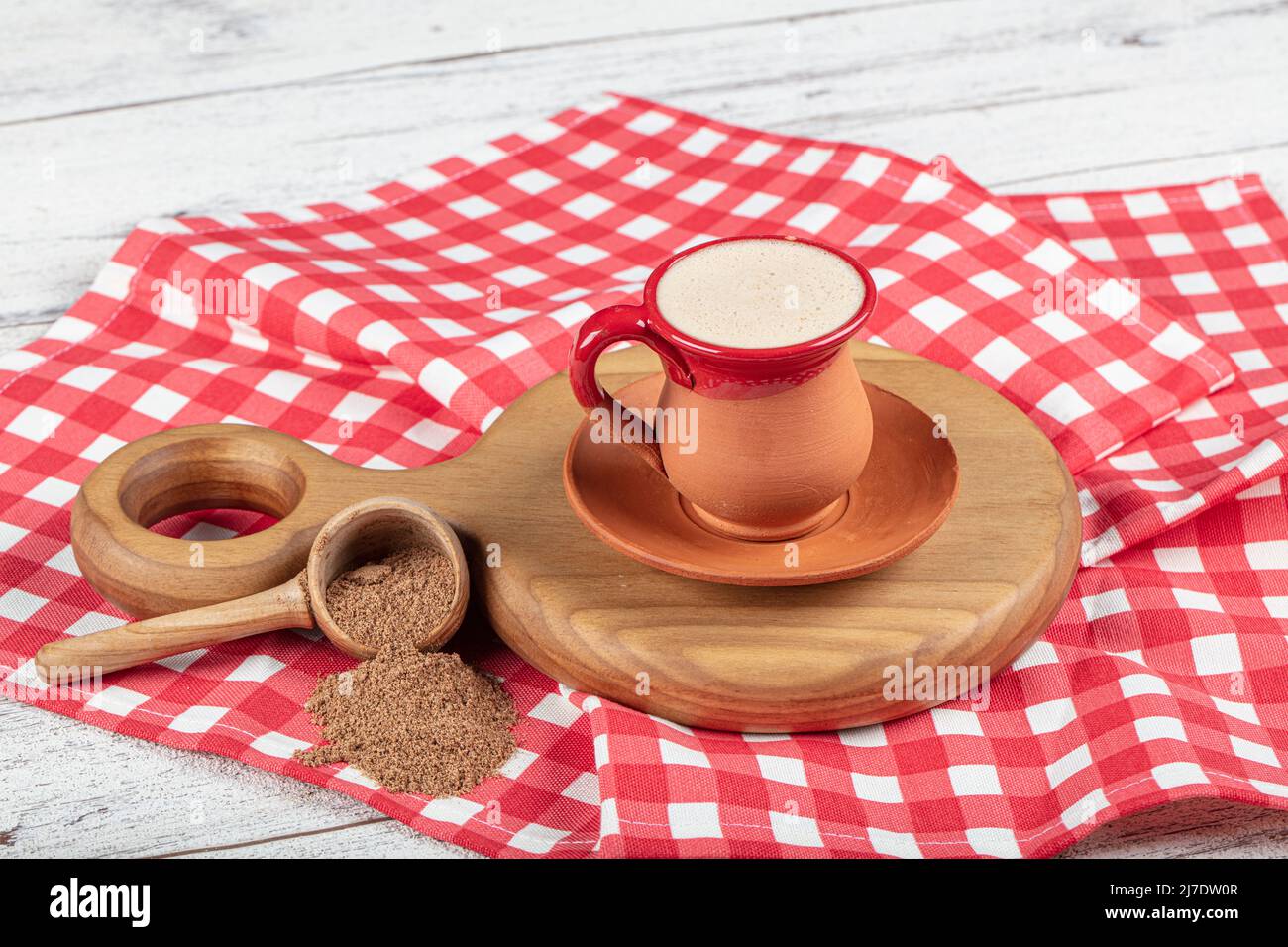 Traditional Turkish Dibek coffee in coffee cup on wooden table. Turkish ...