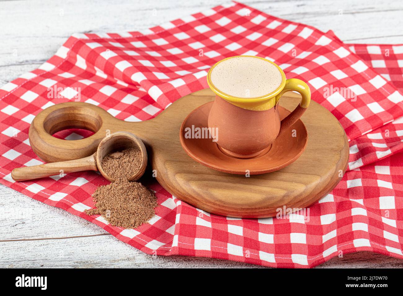 Traditional Turkish Dibek coffee in coffee cup on wooden table. Turkish ...