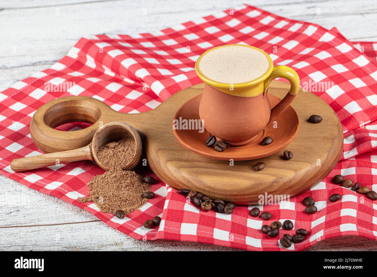 Traditional Turkish Dibek coffee in coffee cup on wooden table. Turkish ...