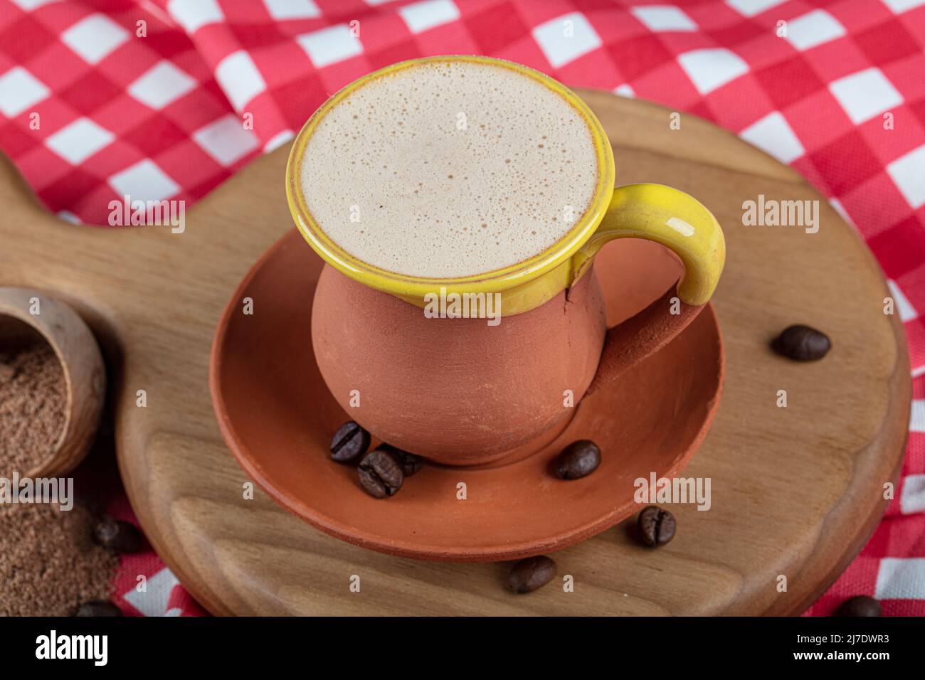 Traditional Turkish Dibek coffee in coffee cup on wooden table. Turkish ...