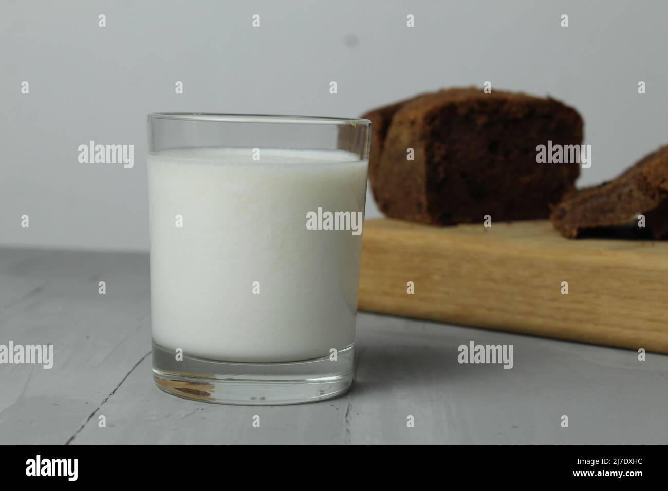 still life made from the milk of a cake cake on a board on a gray ...