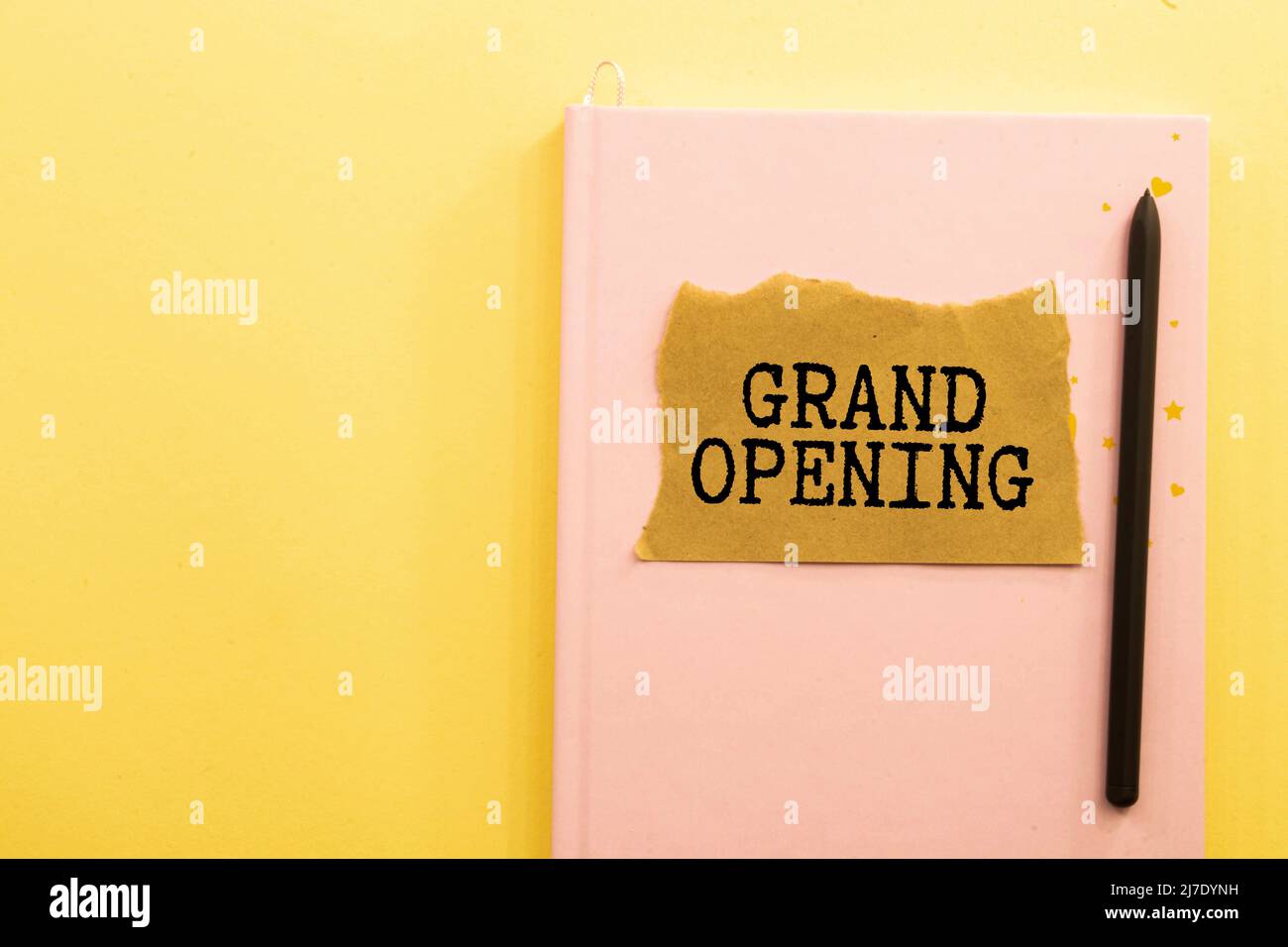 Text message GRAND OPENING on brown torn paper with black backdrop ...