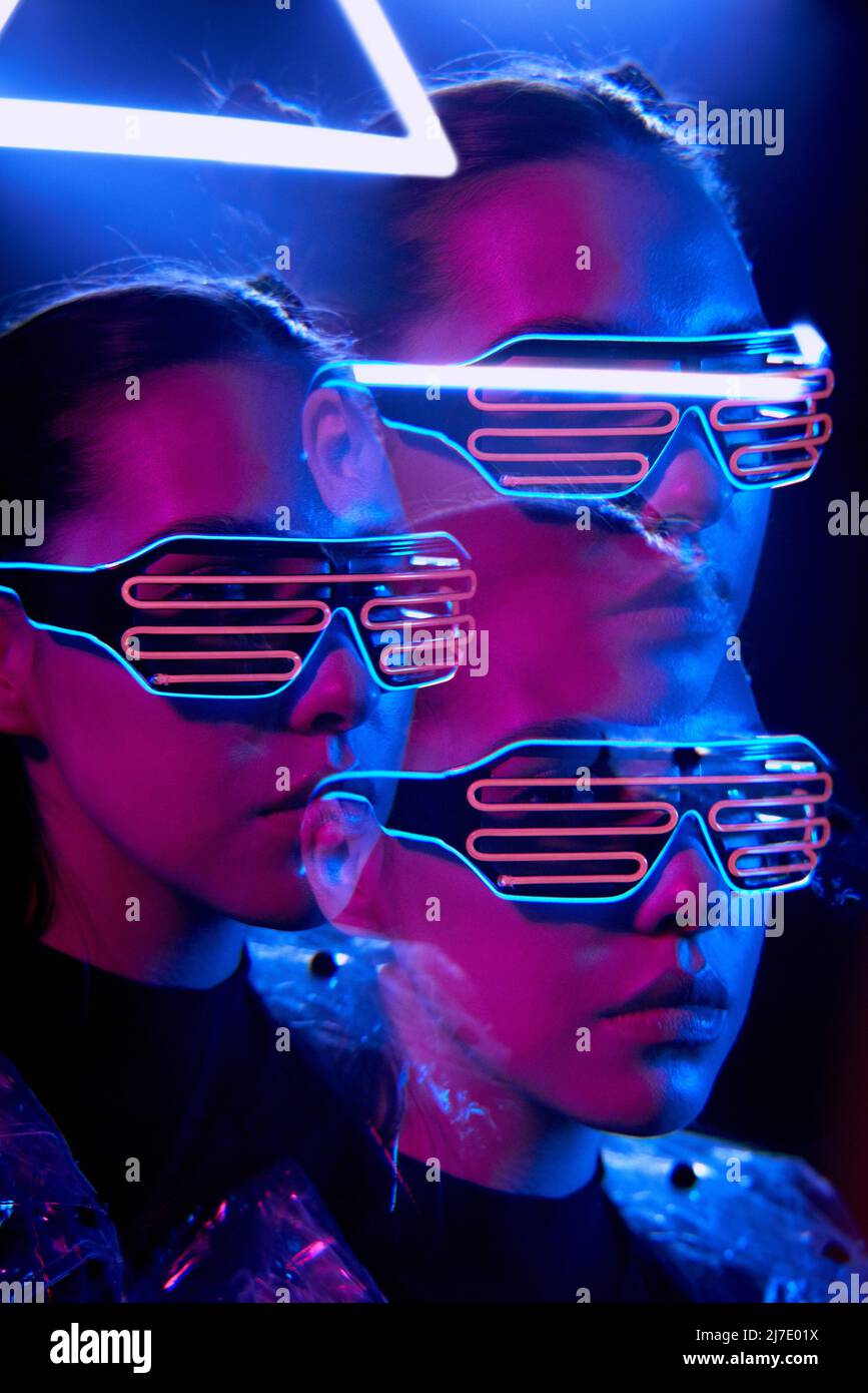 Spinning cyclical image of cyber girl in neon Led goggles in darkness ...