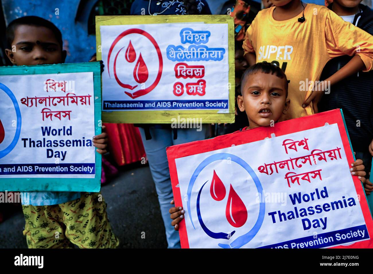 Children hold placards during an event to raise awareness for the blood ...