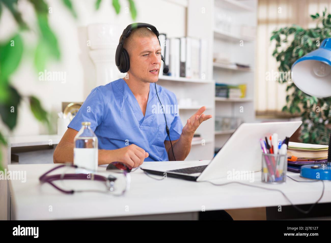 Therapist advising remote patient online via video call on laptop Stock ...