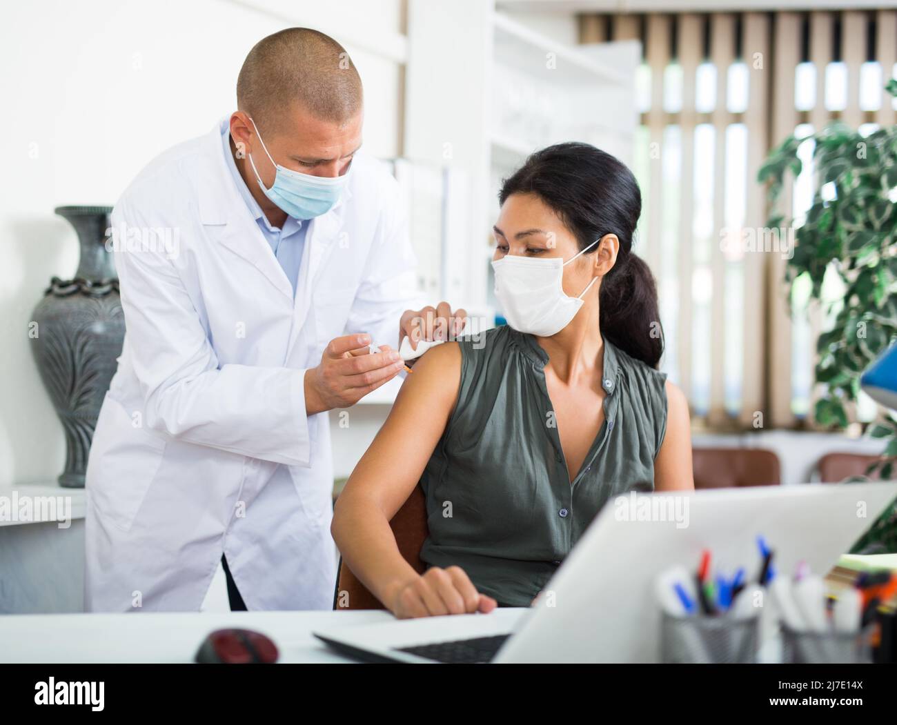 Doctor in protective uniform giving hi-res stock photography and images ...
