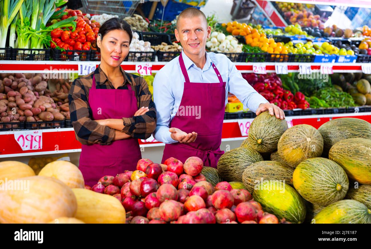 Supermarket workers in uniform standing in salesroom Stock Photo - Alamy