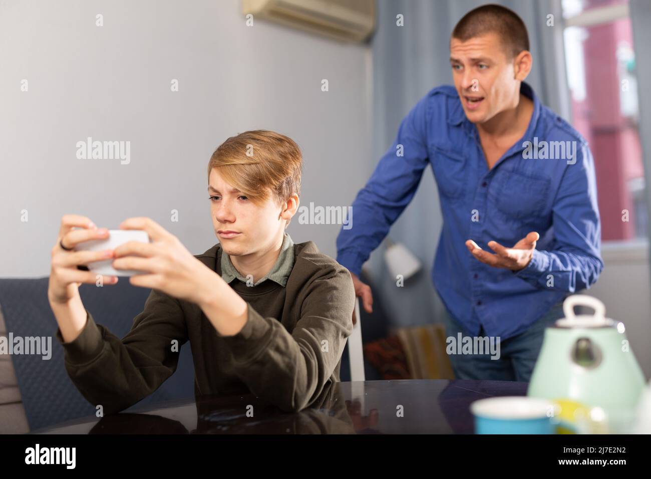 Portrait of angry father quarreling with teenage son Stock Photo - Alamy
