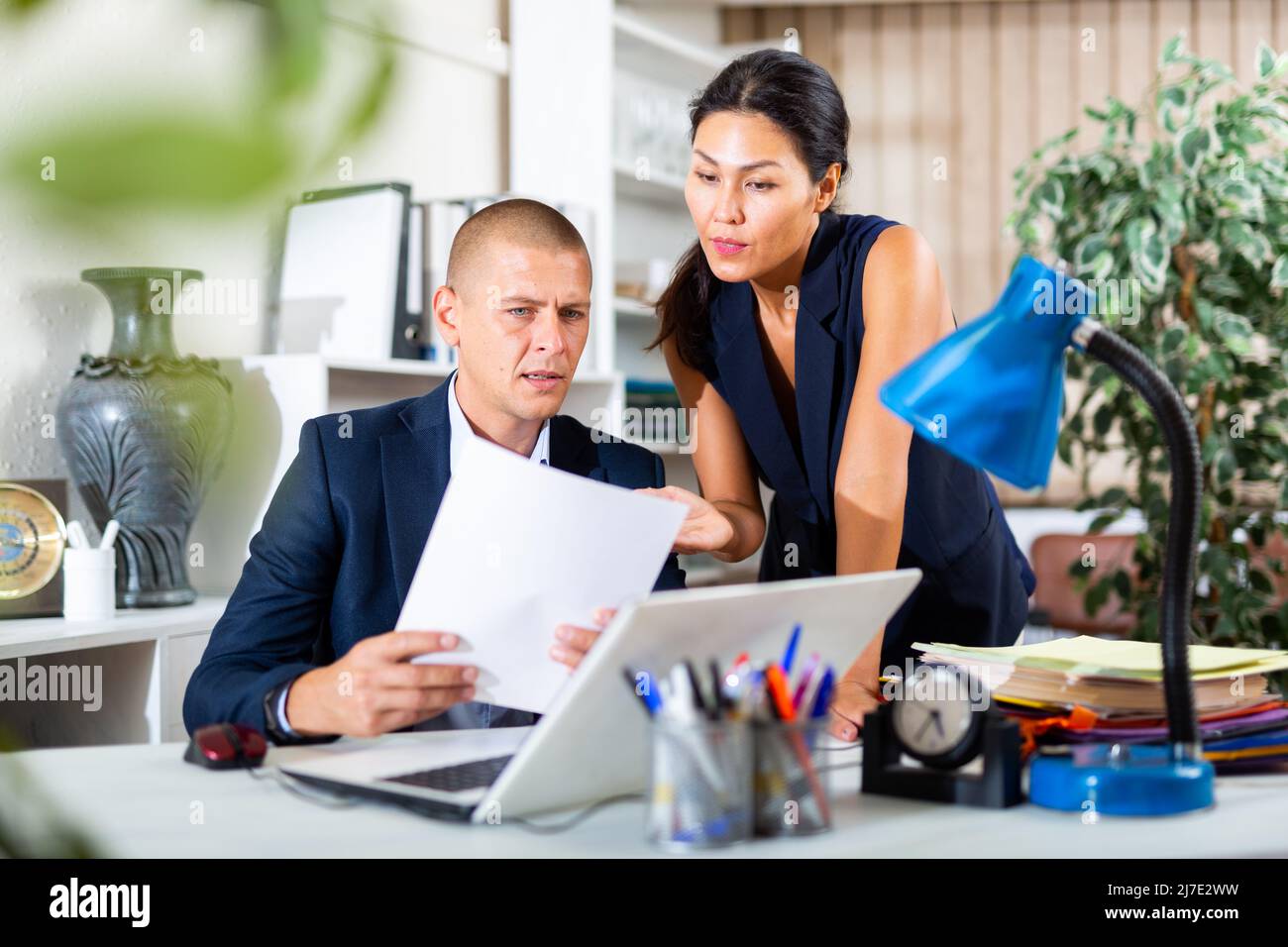 Business people working with papers together Stock Photo - Alamy
