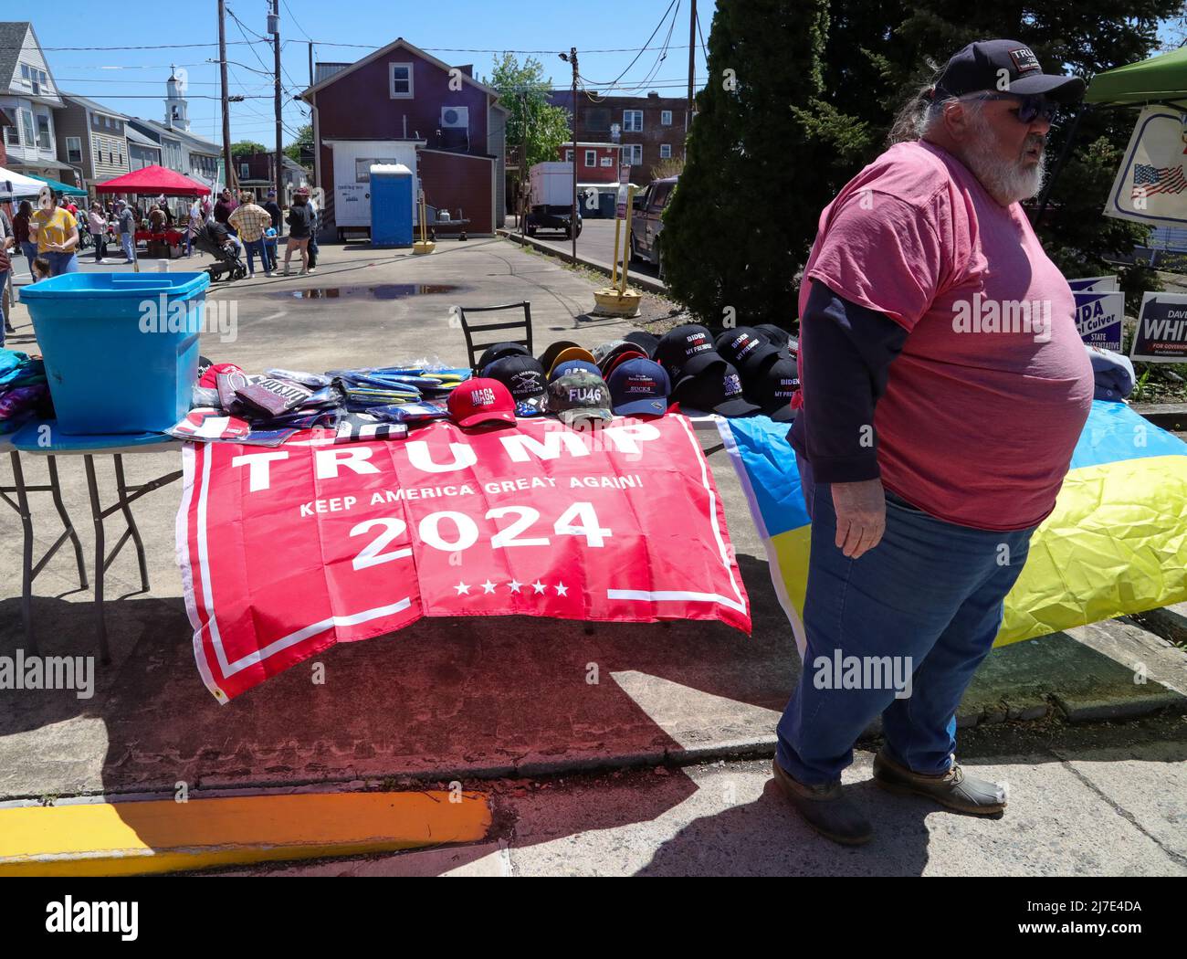 A man displays a Trump 2024, pro-Trump hats and flags, and anti-Biden ...